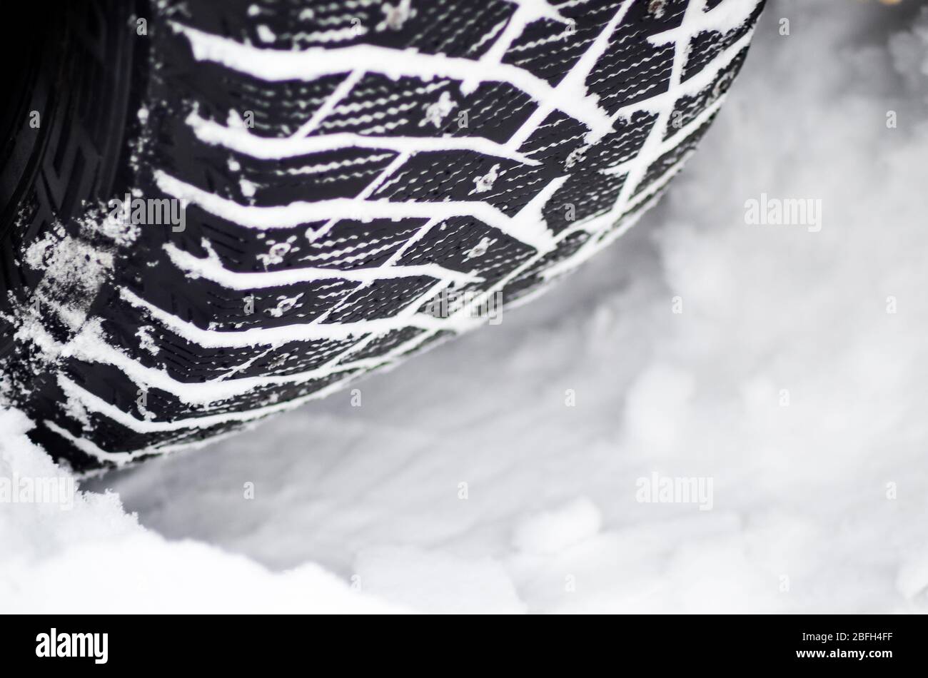 Winter tire with spikes in snow Stock Photo - Alamy