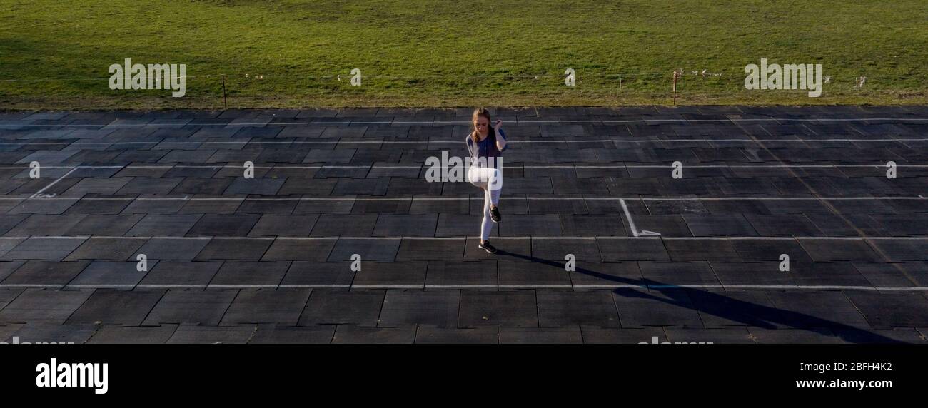 Female athlete preparing legs for cardio workout. Fitness runner doing ...