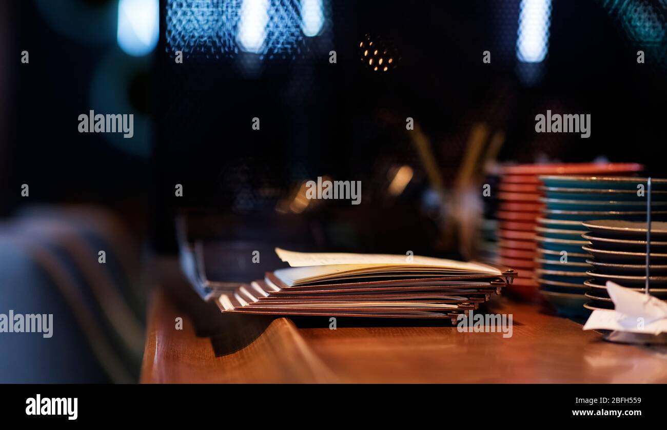 Selective focus of menu on wooden bar counter in restaurant Stock Photo ...