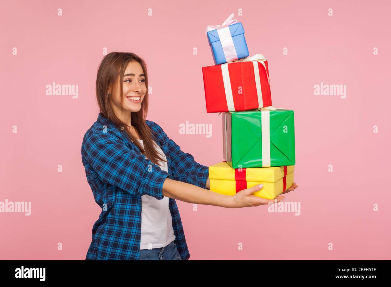 All presents for you! Side view of generous kind girl giving many gift ...