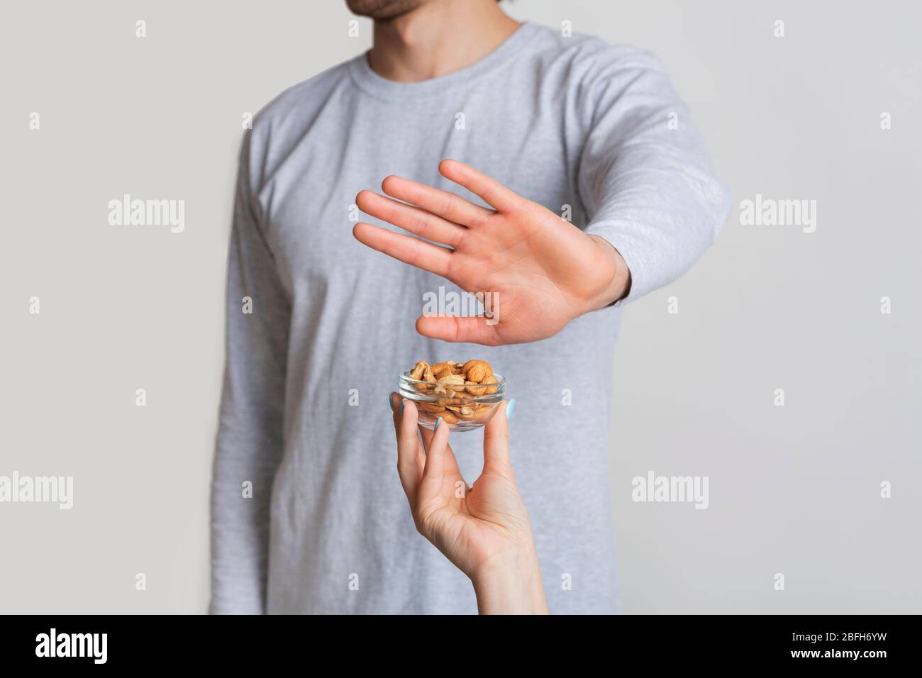 Allergy concept. Man refuses nuts, free space Stock Photo - Alamy