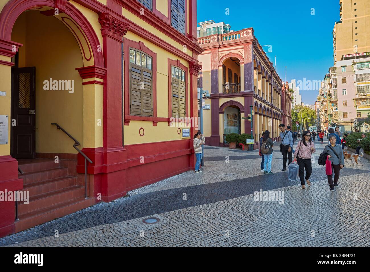 People walking by the colourful building of the Macao Central Library ...