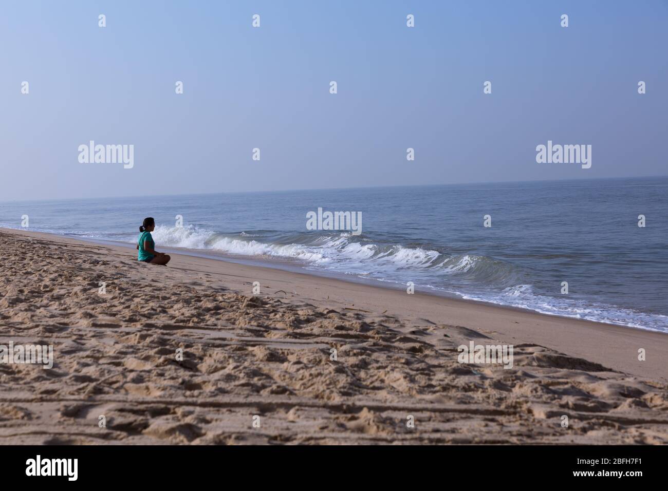 Mararikulam, Kerala - January 6, 2019: Woman meditating on the beach in ...