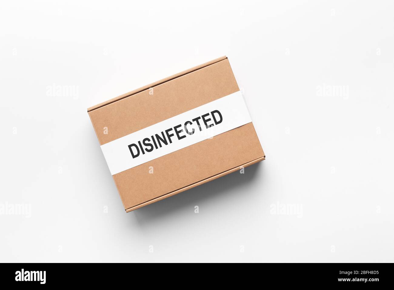 Cardboard box with text disinfected on white Stock Photo - Alamy
