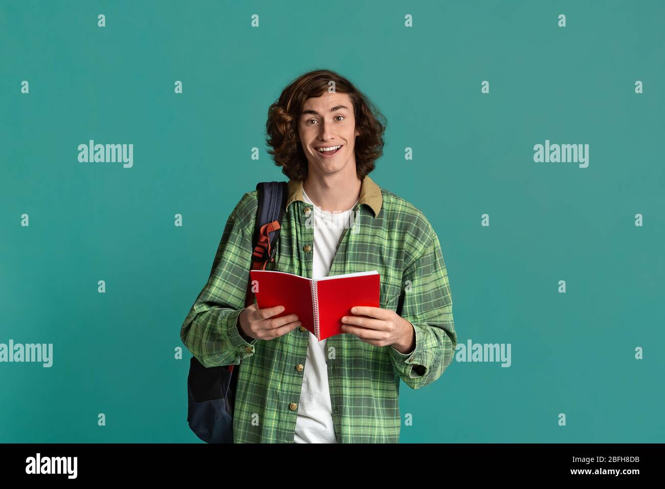 Back to school. Happy student with open notebook and backpack on ...