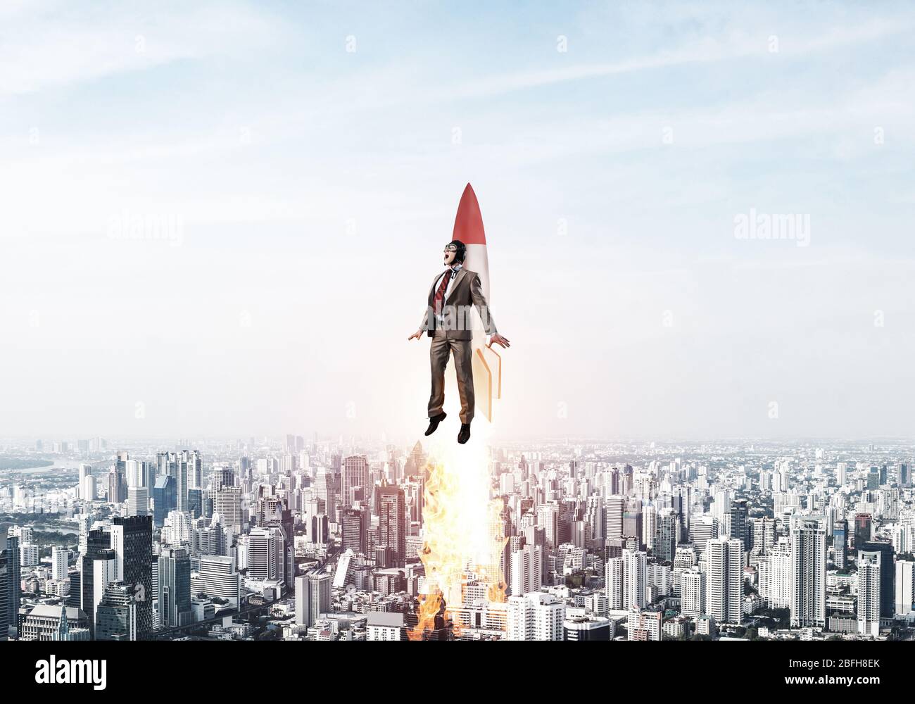 Business person in aviator hat flying on rocket Stock Photo - Alamy