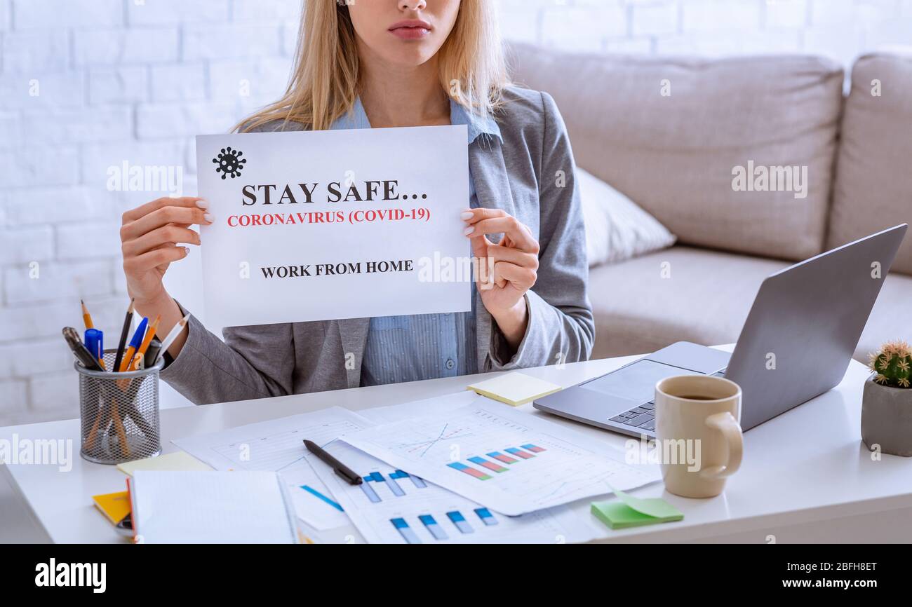 Work from home. Woman with inscription on remote workplace Stock Photo ...