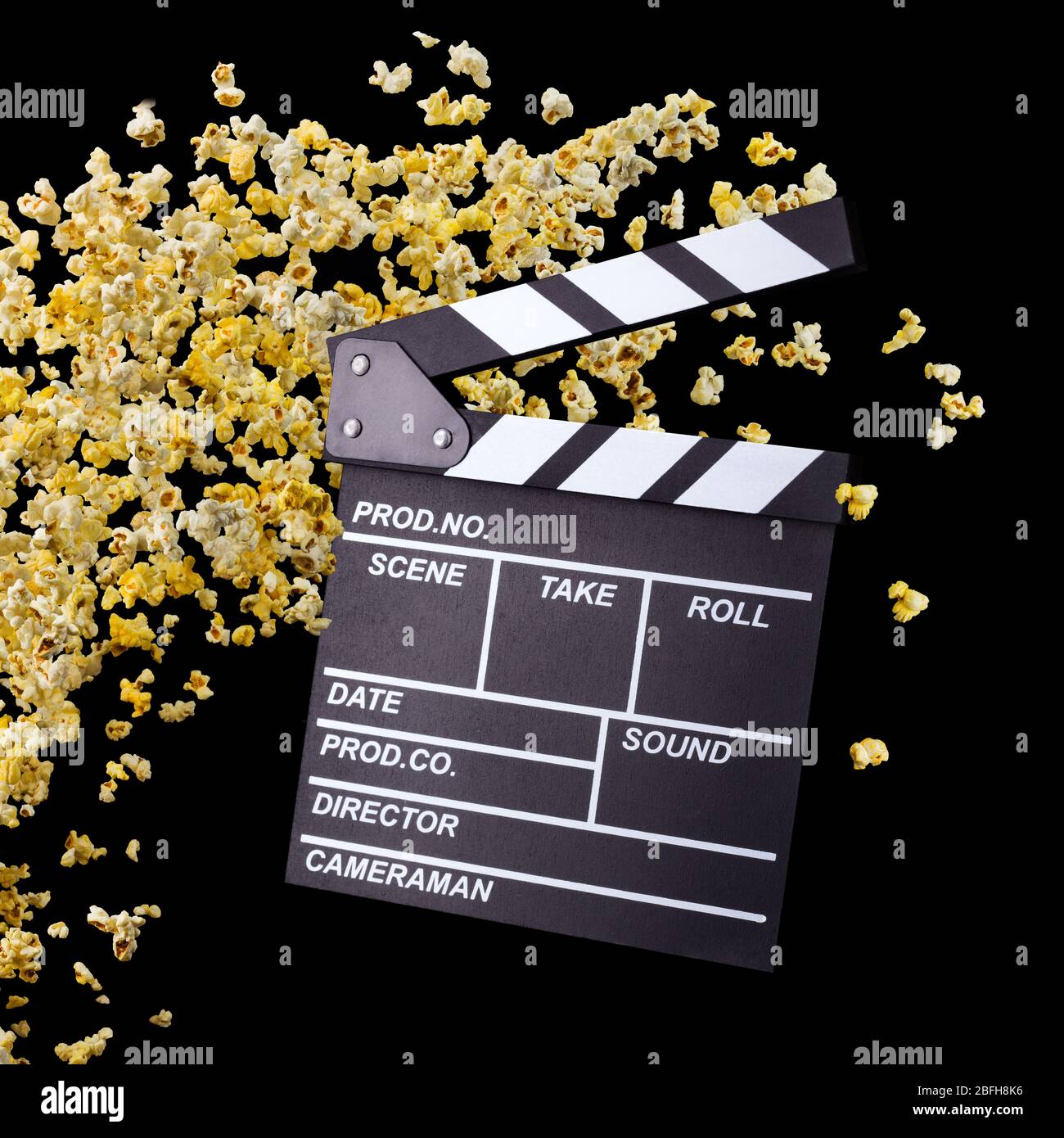 Flying popcorn and film clapper board isolated on black background ...