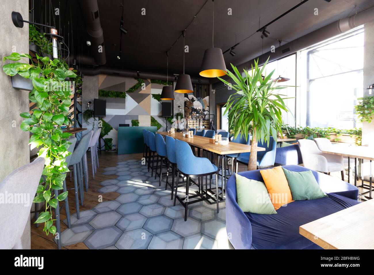 Light modern interior of urban restaurant or cafe with dining places ...