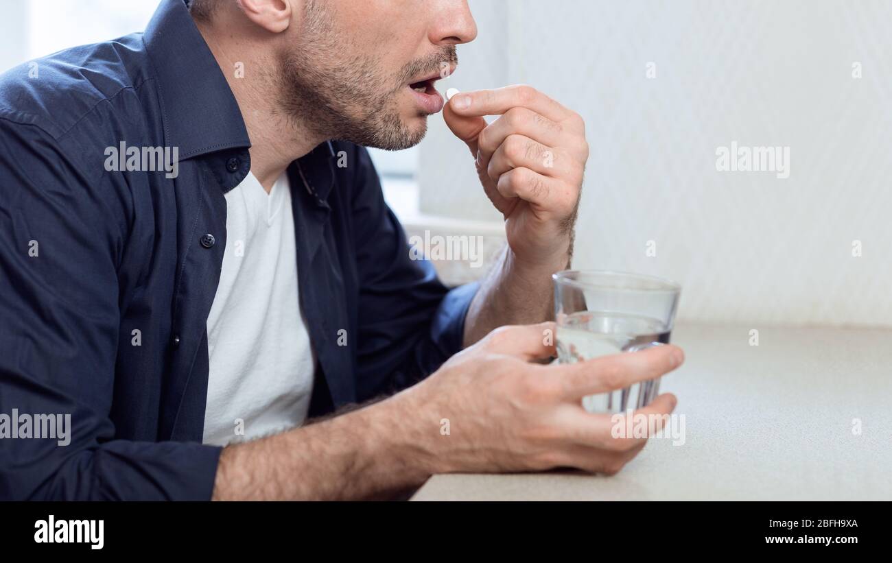 Middle man taking pill hi-res stock photography and images - Alamy