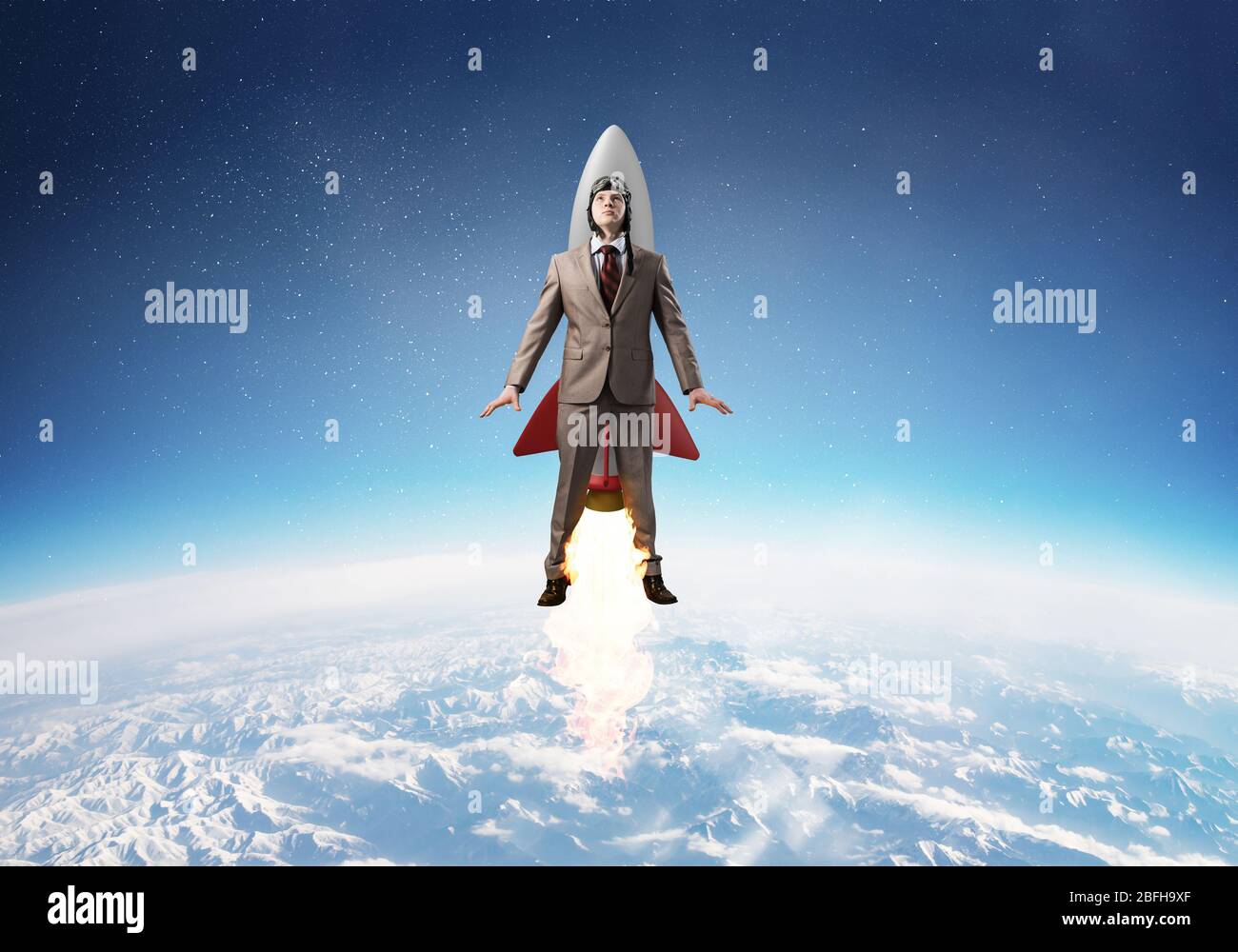 Business person in aviator hat flying on rocket Stock Photo - Alamy