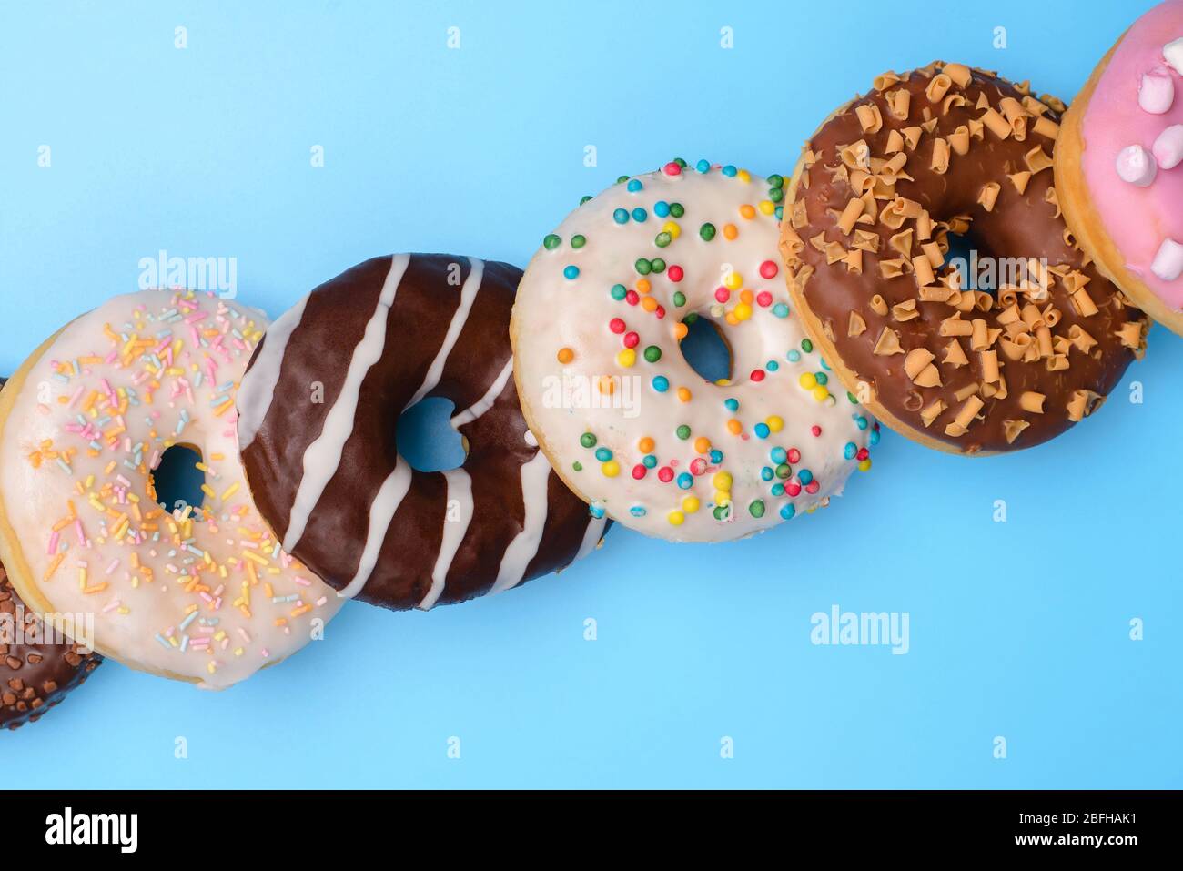 Top above overhead close up view photo of different yummy donuts lying ...