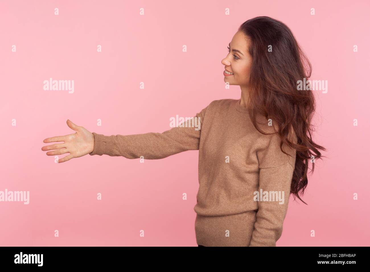 Hello, nice to meet! Side view of friendly kind young woman with ...