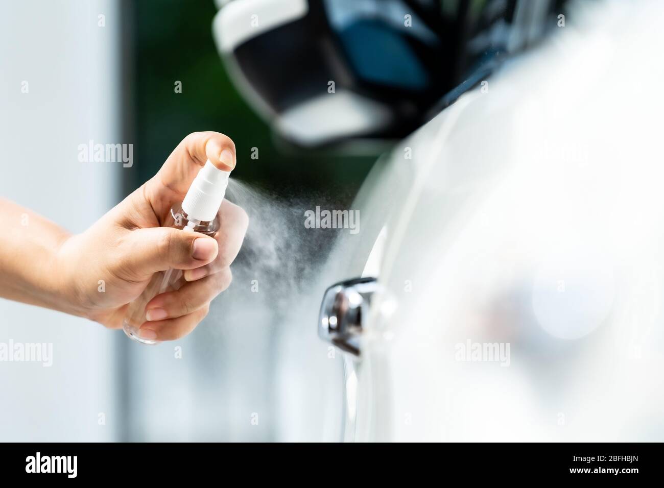 Closeup car wash clening using hand spraying alcohol, disinfectant ...