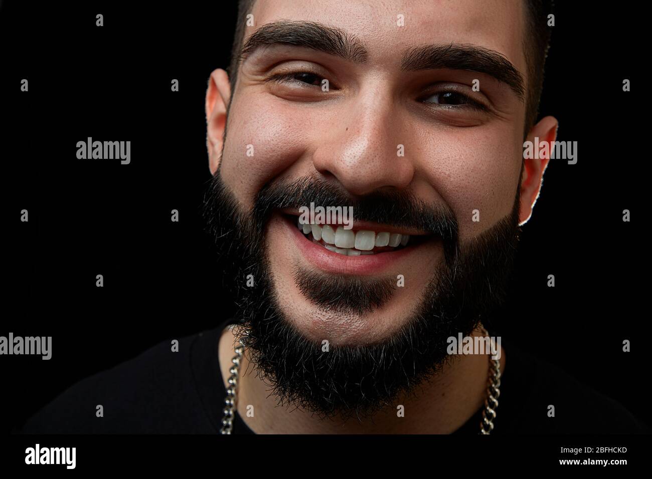 close-up of a dramatic portrait of a smiling young guy, a musician ...