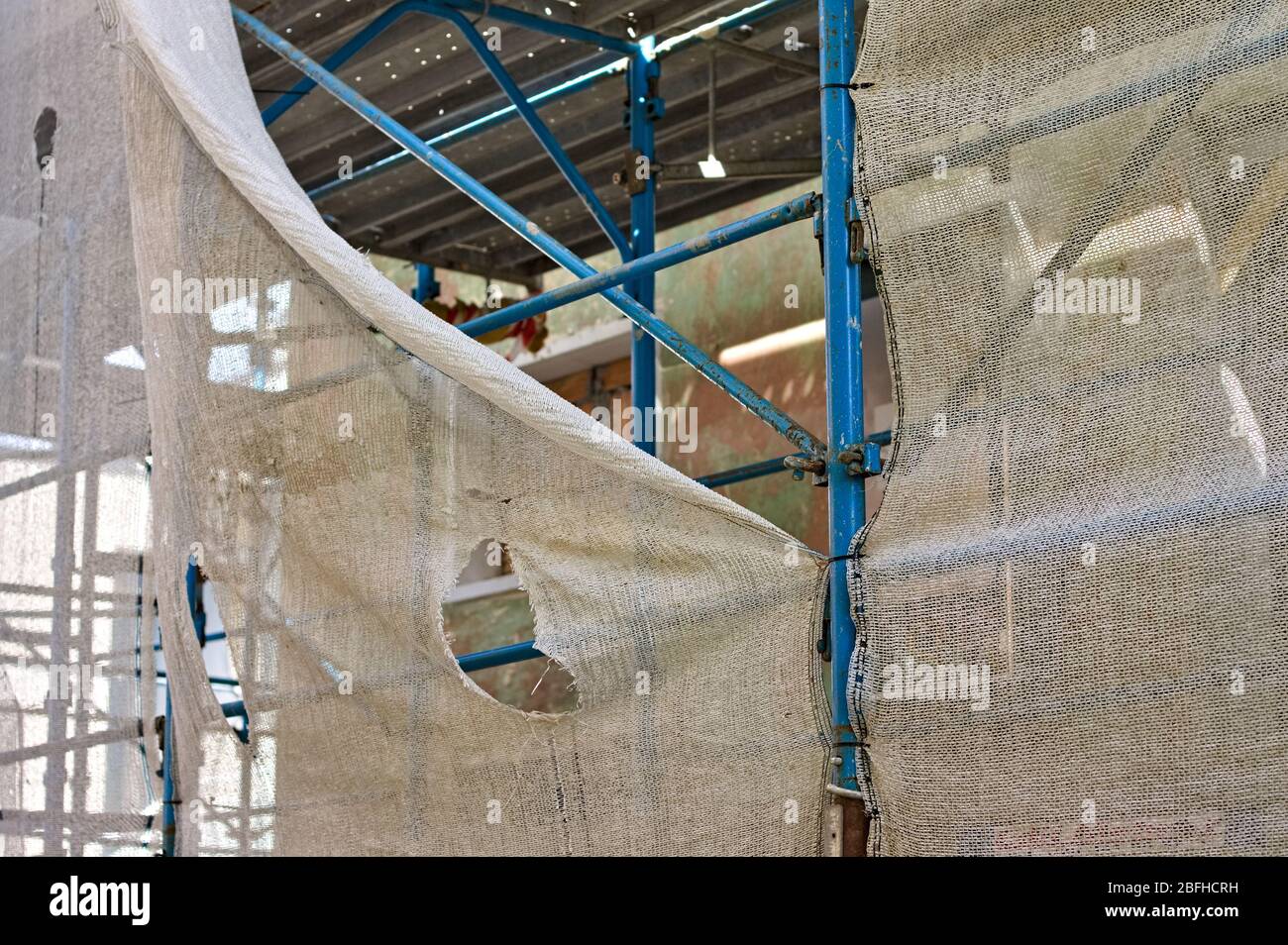 A broken scaffolding protection net in a building site (Pesaro, Marche ...