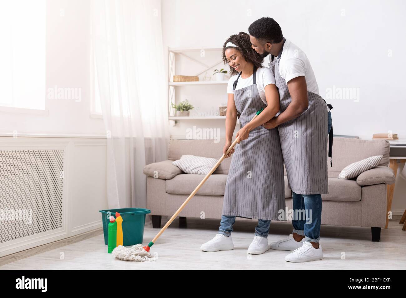 Young man mopping floor home hi-res stock photography and images - Alamy