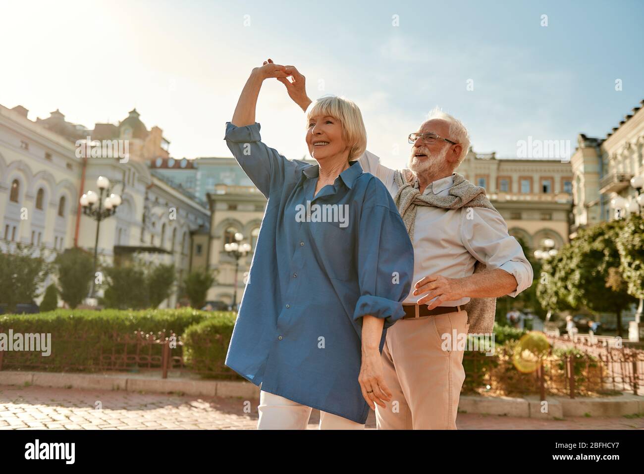 Spontaneous dance. Portrait of happy seniour couple smiling while ...