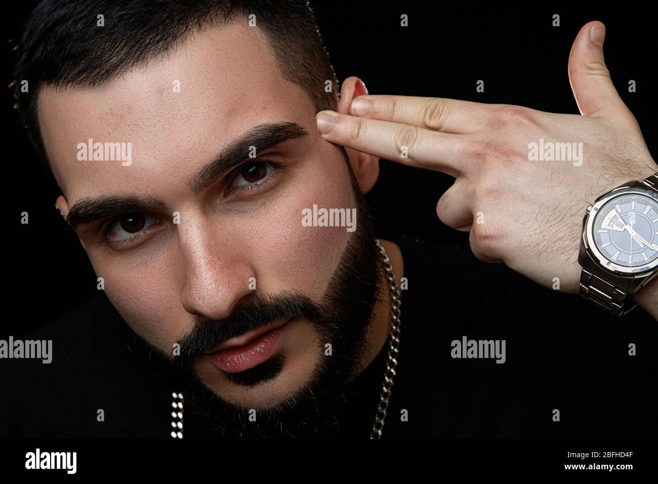 close-up of a dramatic portrait of a young serious guy, musician ...
