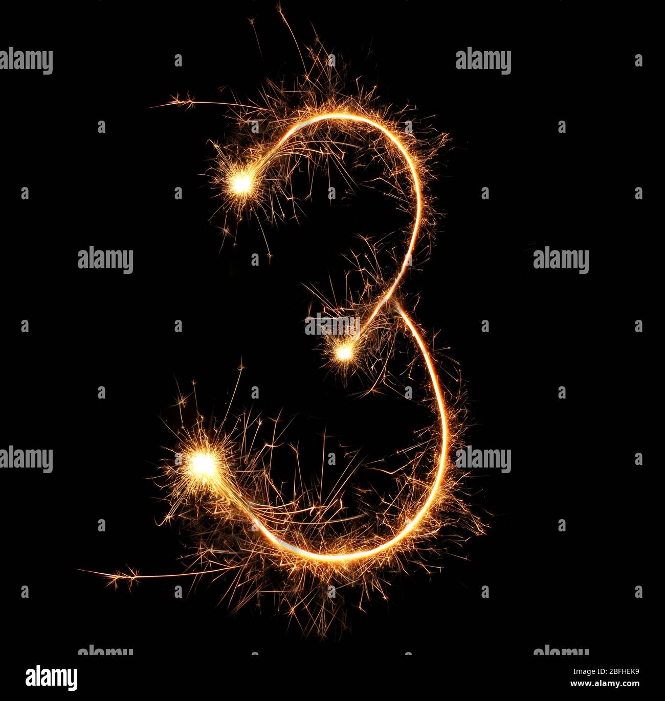Number "three" sparklers on black background Stock Photo - Alamy