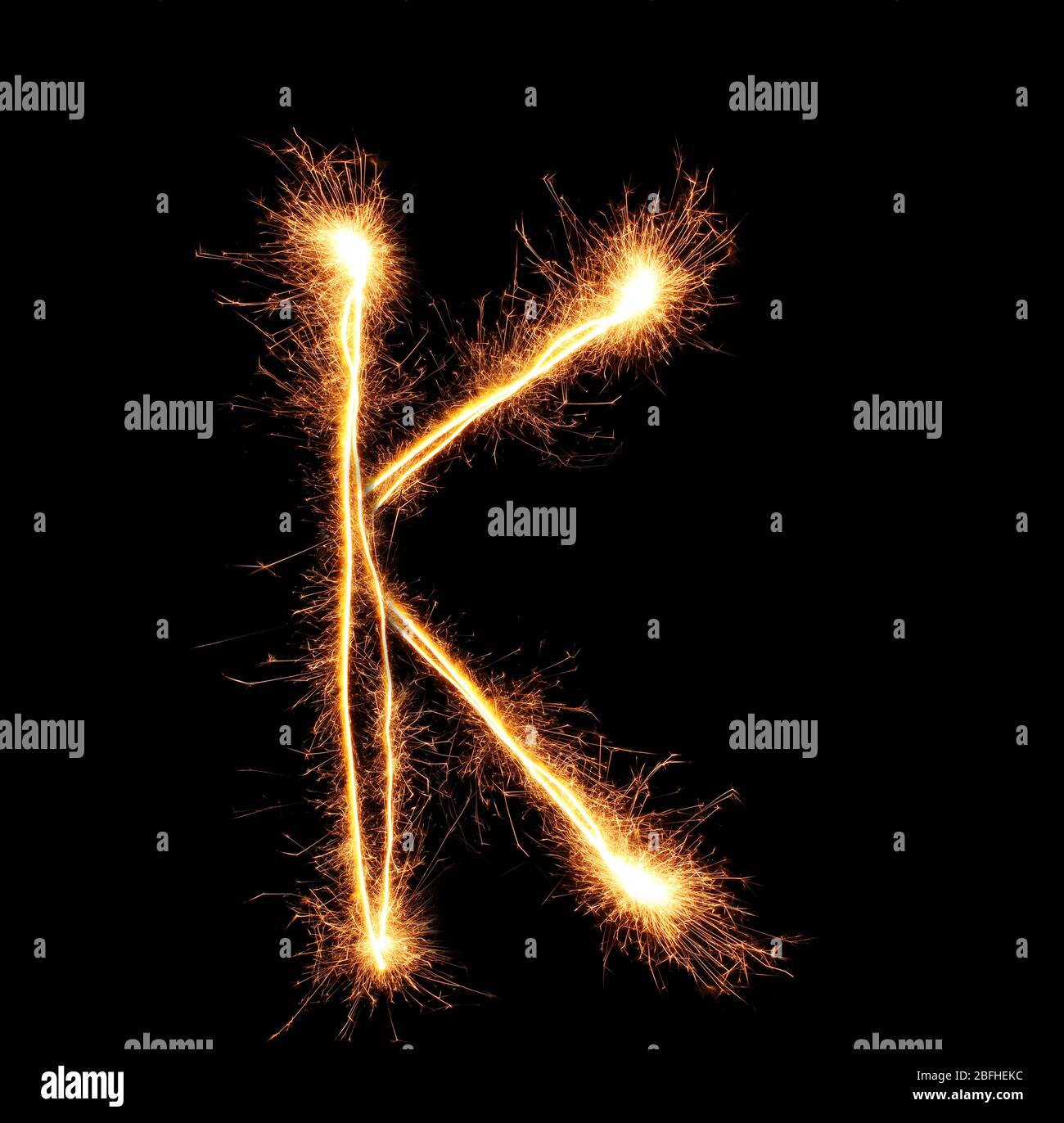 Letter "K" sparklers on black background Stock Photo - Alamy