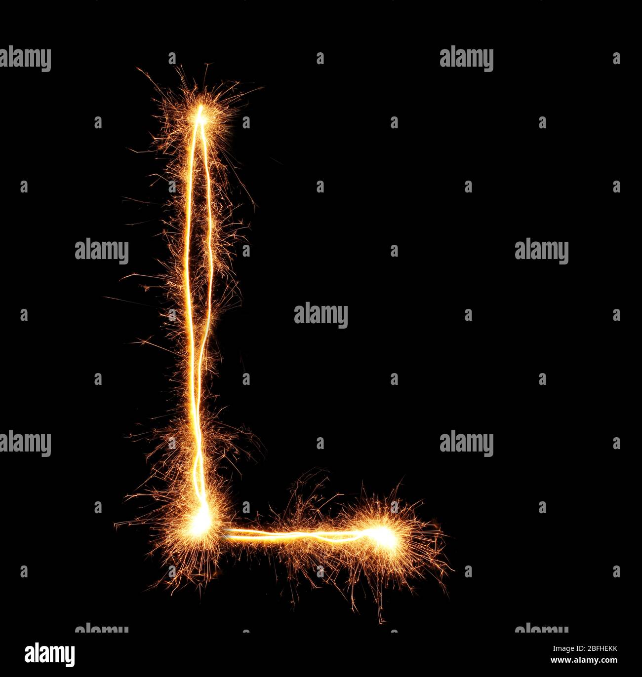 Letter "L" sparklers on black background Stock Photo - Alamy