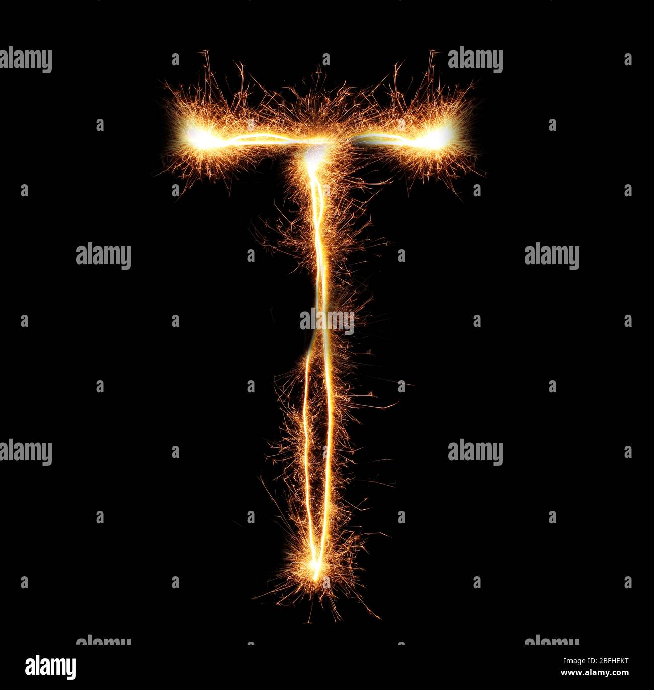 Letter "T" sparklers on black background Stock Photo - Alamy