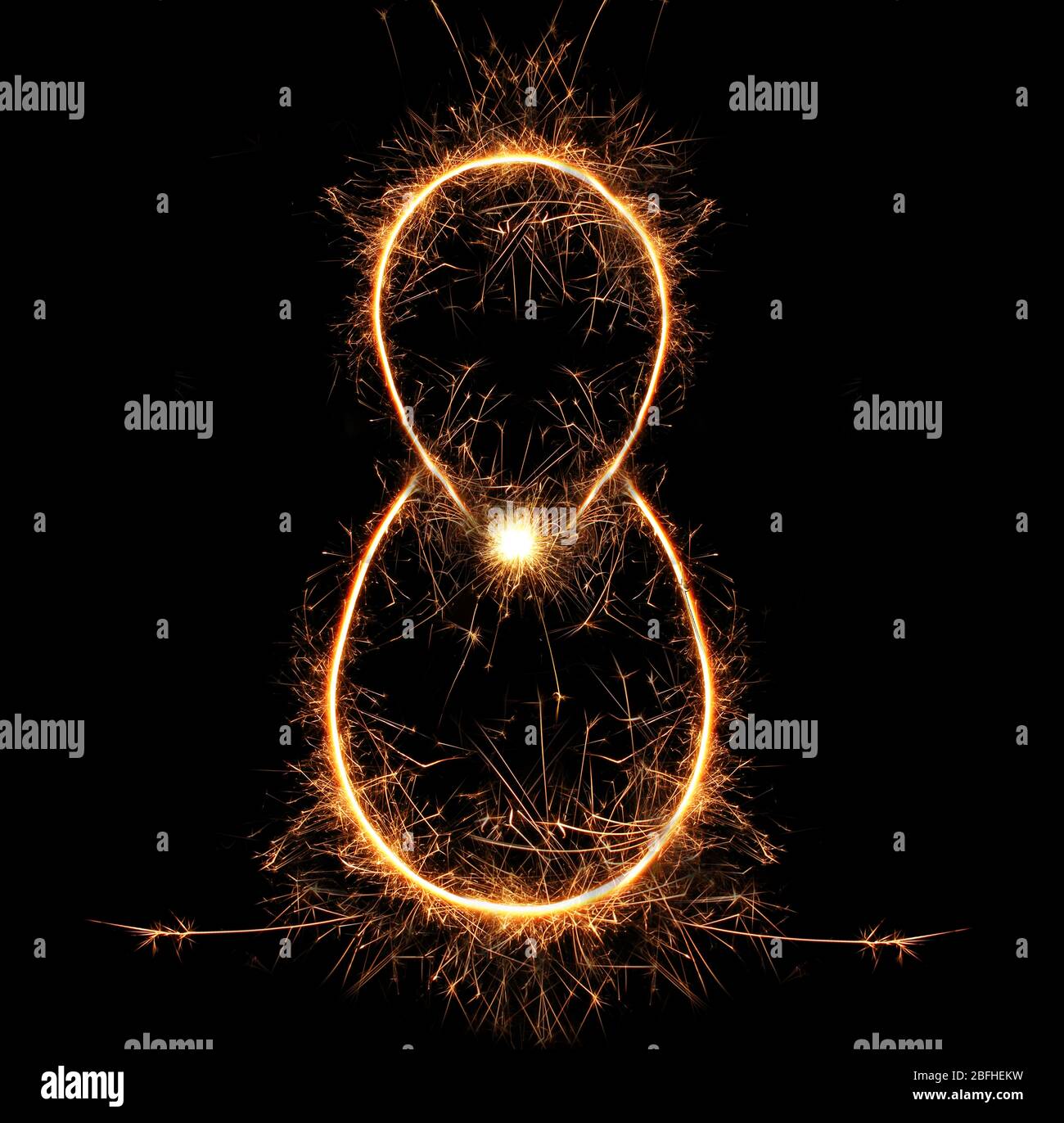 Number "eight" sparklers on black background Stock Photo - Alamy