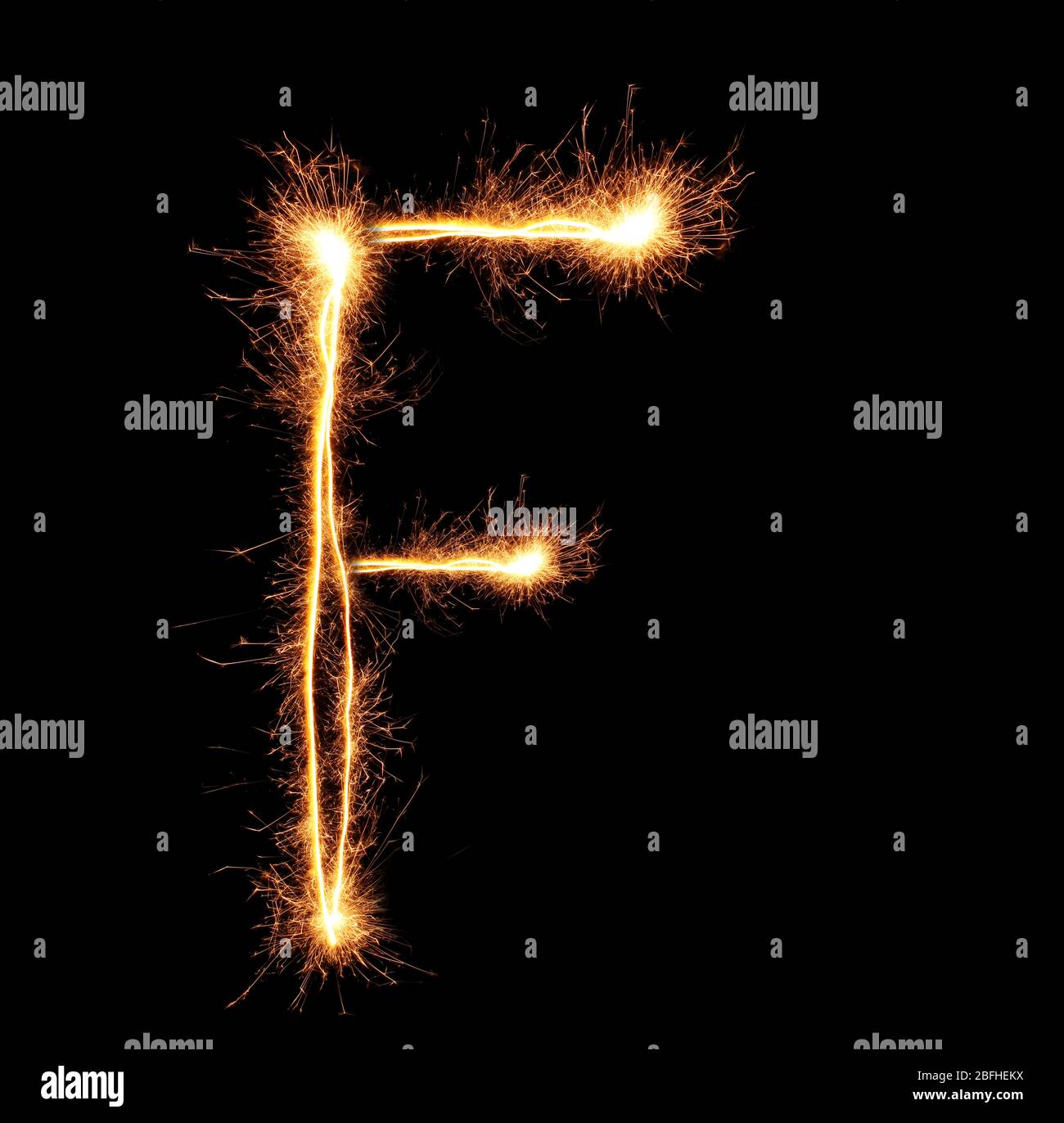 Letter "F" sparklers on black background Stock Photo - Alamy