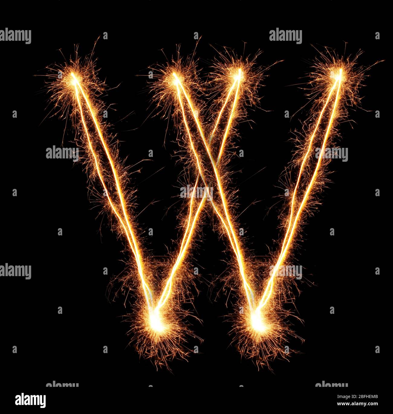 Letter "W" sparklers on black background Stock Photo - Alamy