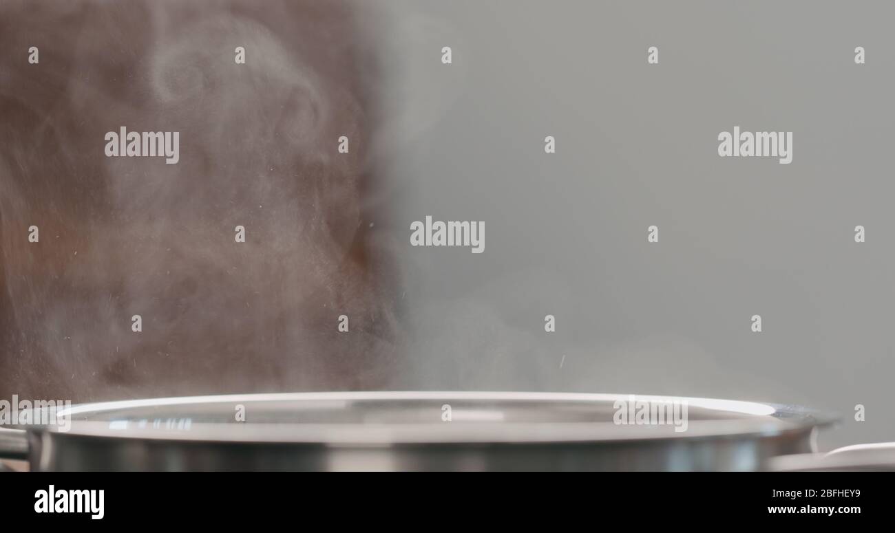 steam rising from pot while cooking closeup Stock Photo - Alamy