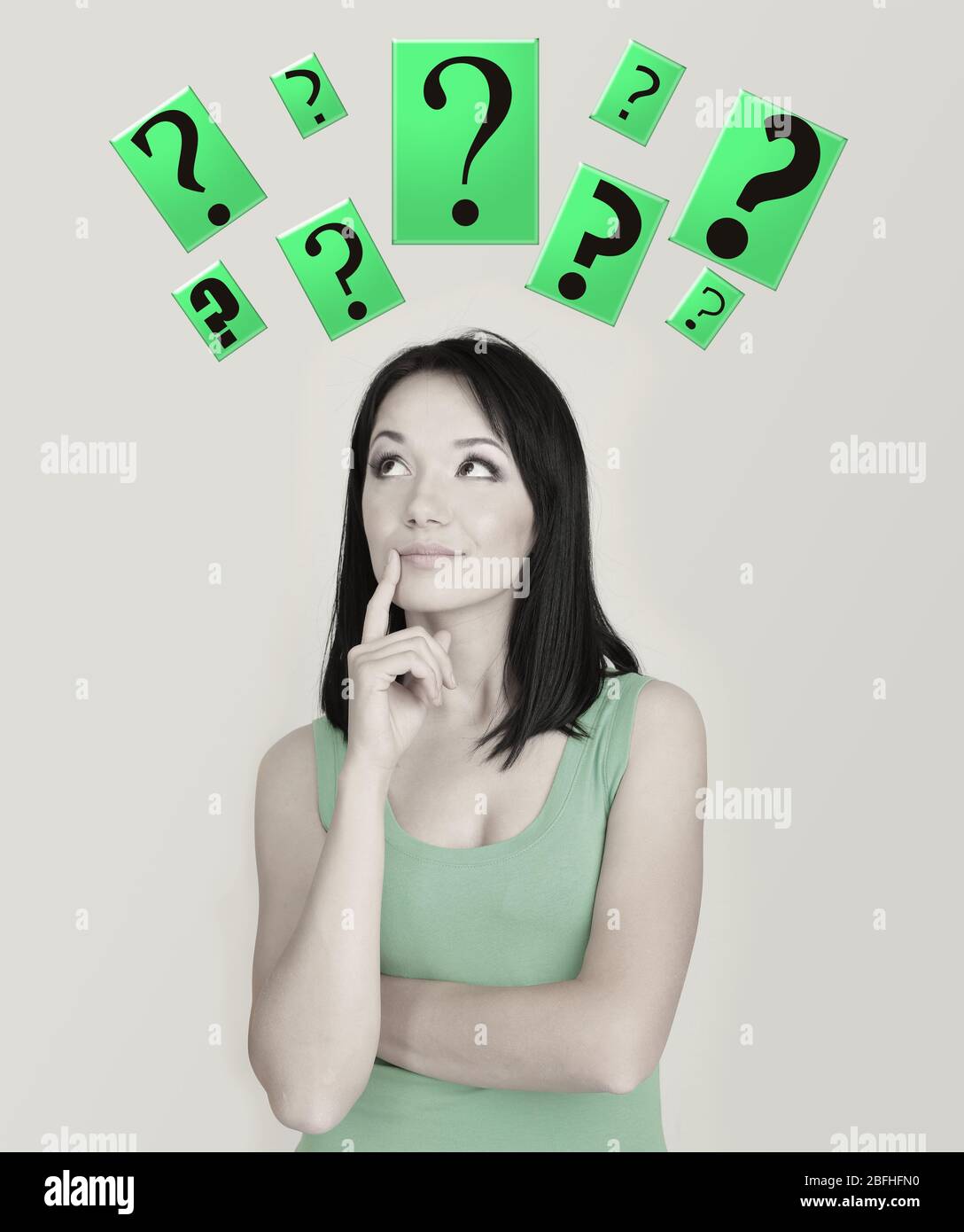 Girl thinking surrounded by question marks on beige background Stock ...