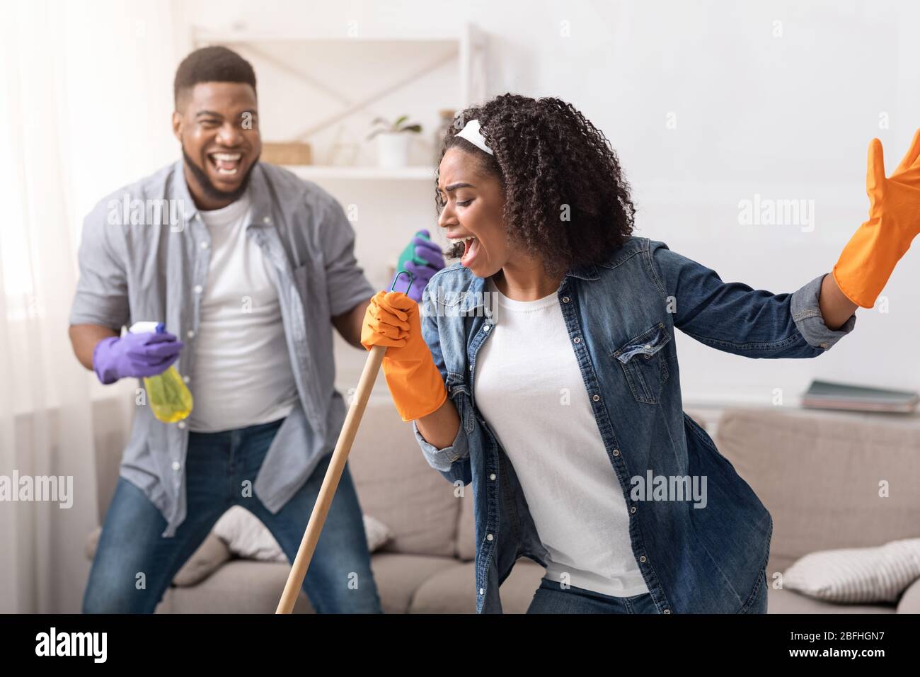 Happy Housekeeping. Cheerful African Couple Having Fun While Cleaning ...