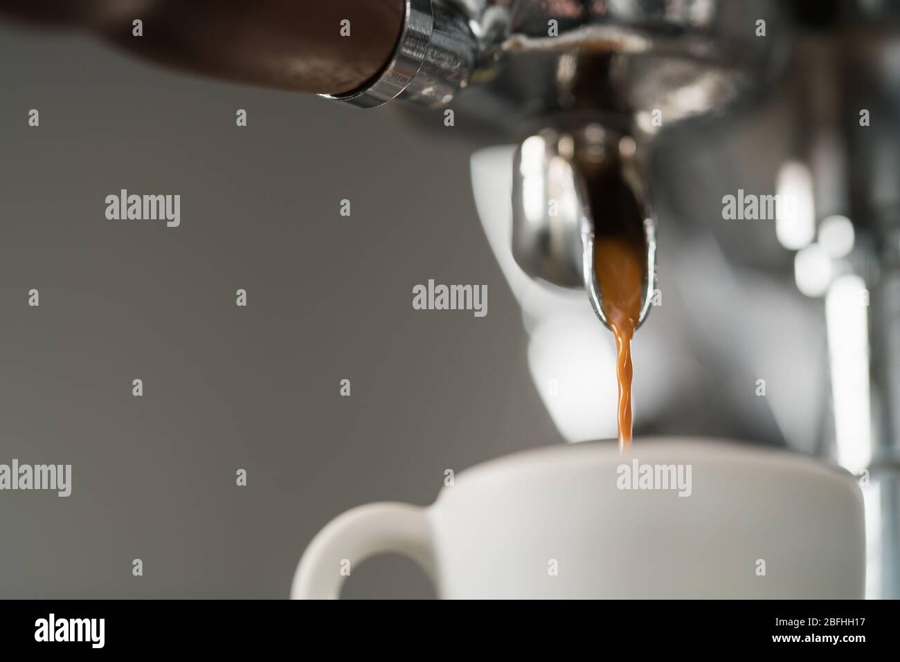 Espresso brewing with single spout portafilter on professional coffee ...