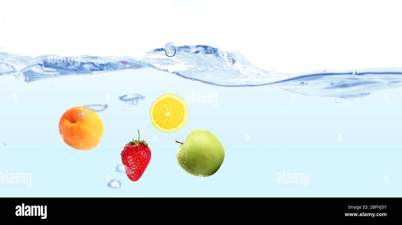 Fresh fruits dropped into water Stock Photo - Alamy