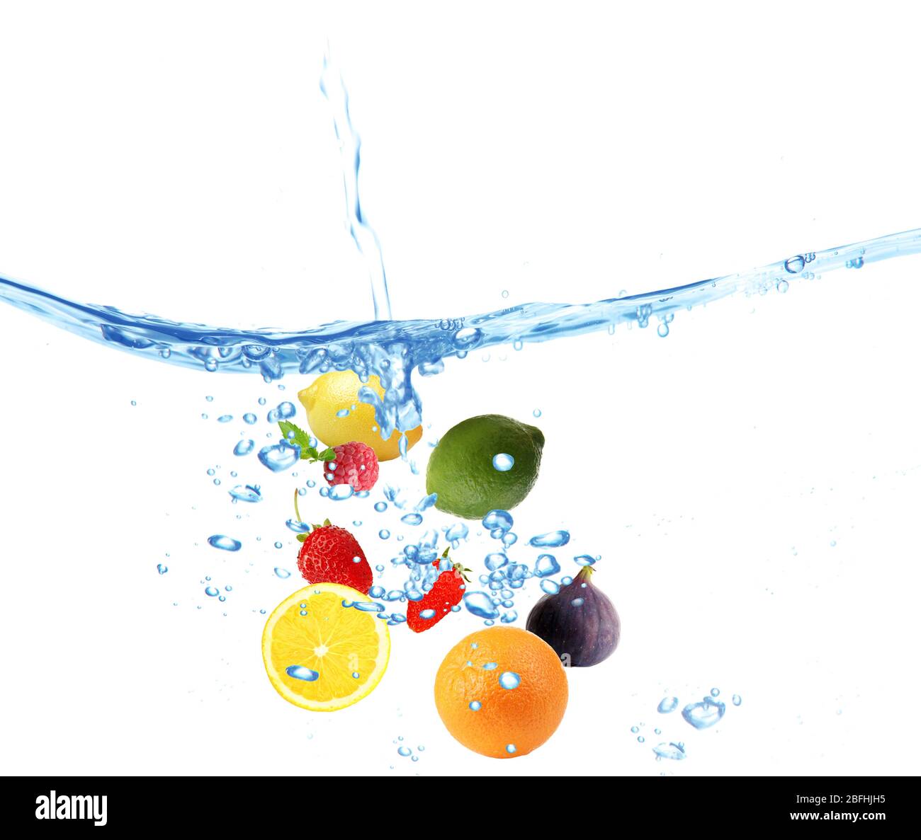 Fresh fruits dropped into water Stock Photo - Alamy