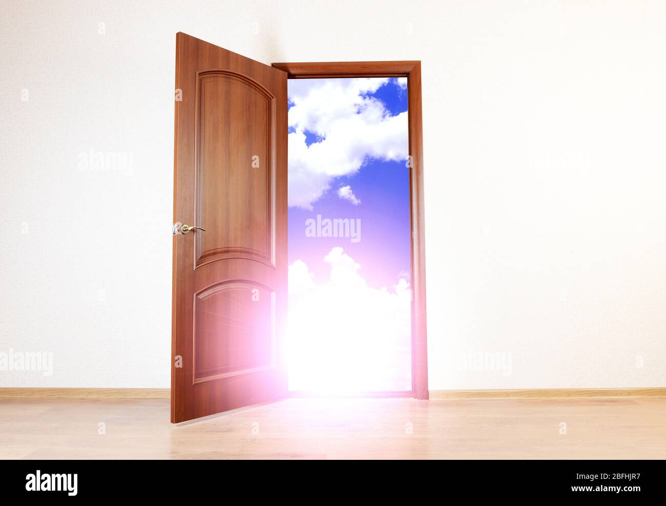 Open door to new life in room Stock Photo - Alamy