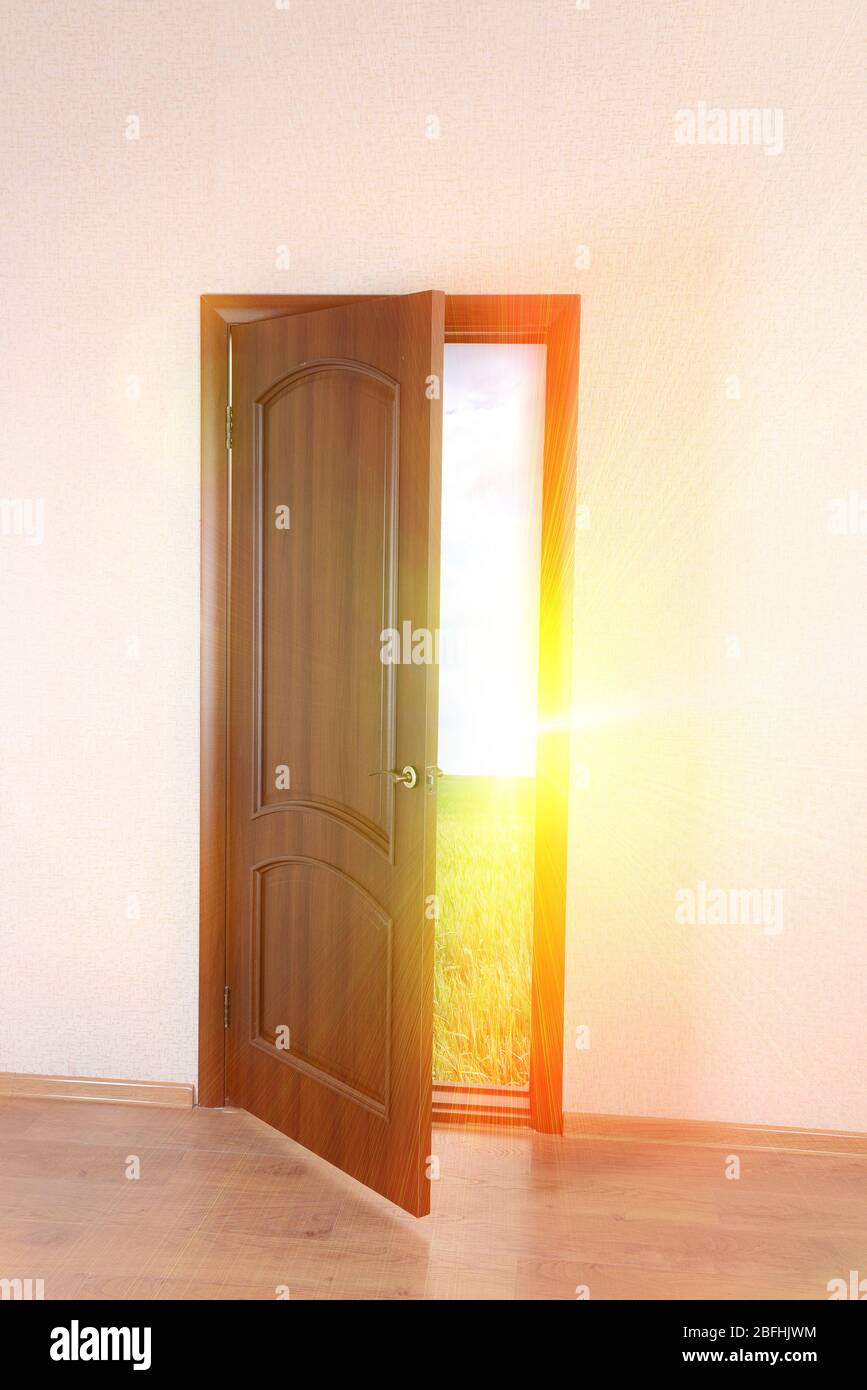 Open door to new life in room Stock Photo - Alamy