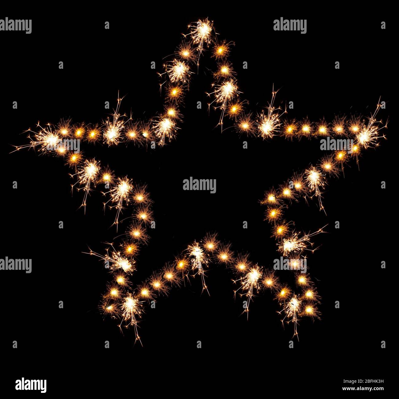 Christmas sparklers in shape of star on black background Stock Photo ...