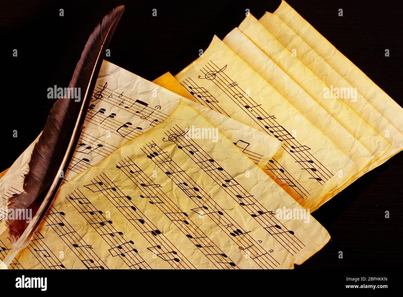 Musical notes and feather Stock Photo - Alamy