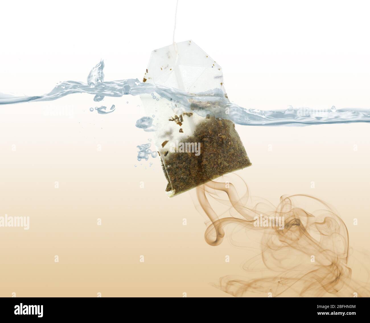 Tea bag dipped in hot water Stock Photo - Alamy