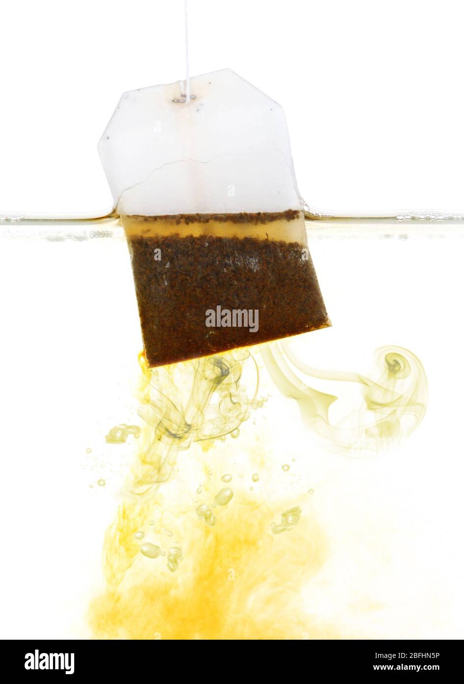 Tea bag dipped in hot water Stock Photo - Alamy