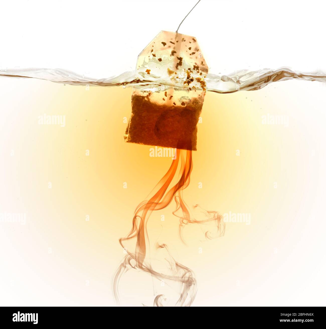 Tea bag dipped in hot water Stock Photo - Alamy