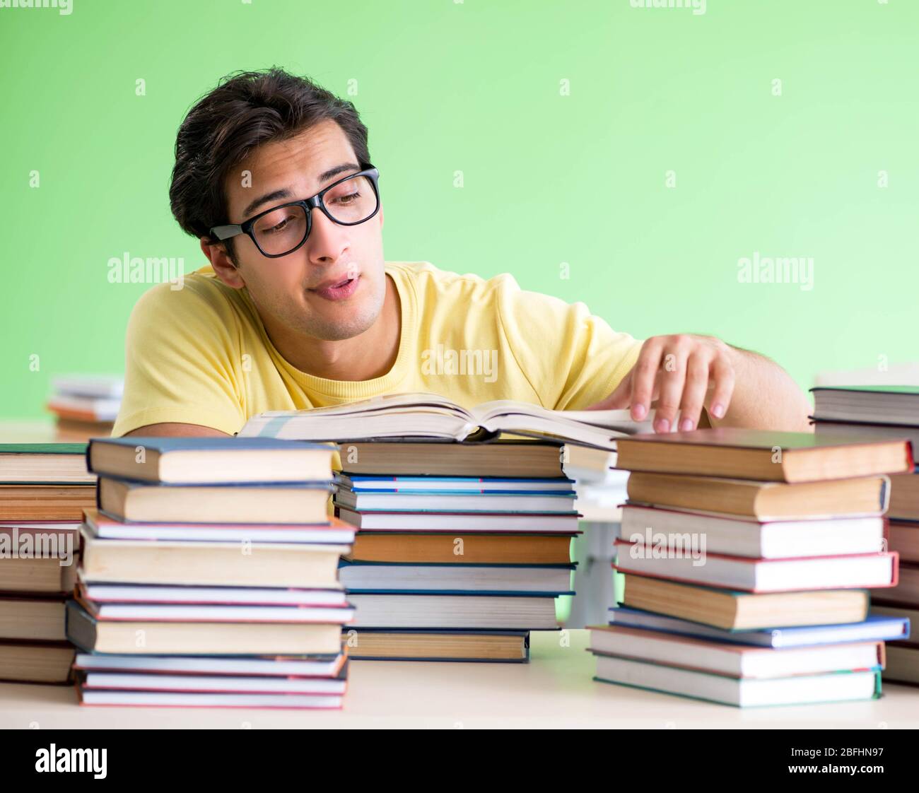 The student with too many books to read before exam Stock Photo - Alamy