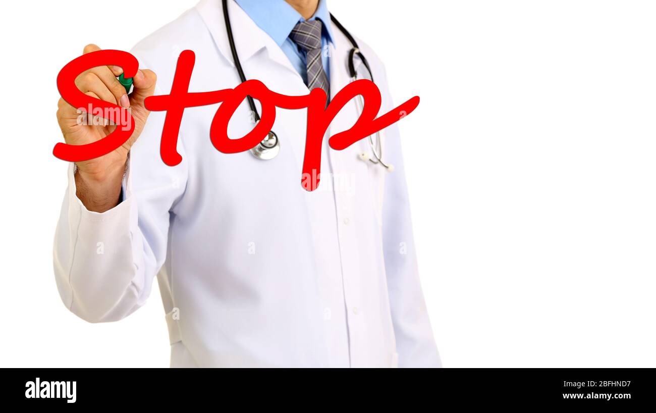 Doctor writing word Stop on transparent board Stock Photo - Alamy