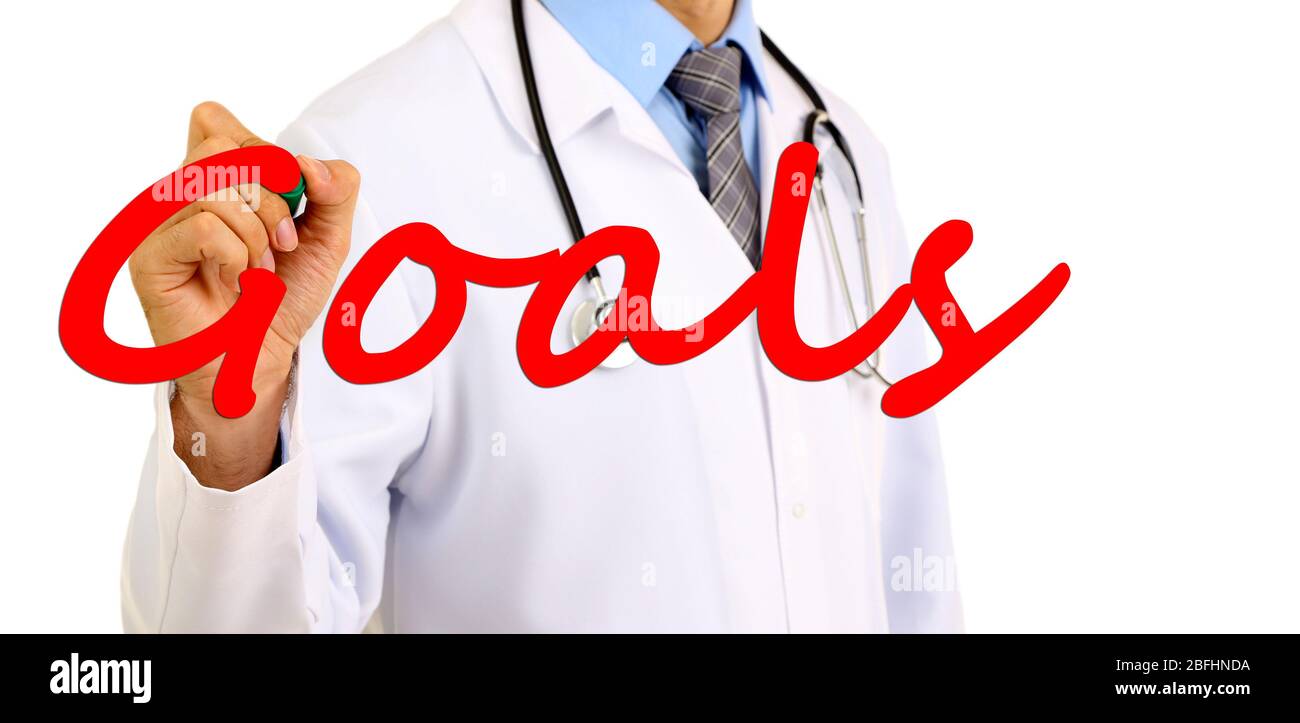 Doctor writing word Goals on transparent board Stock Photo - Alamy