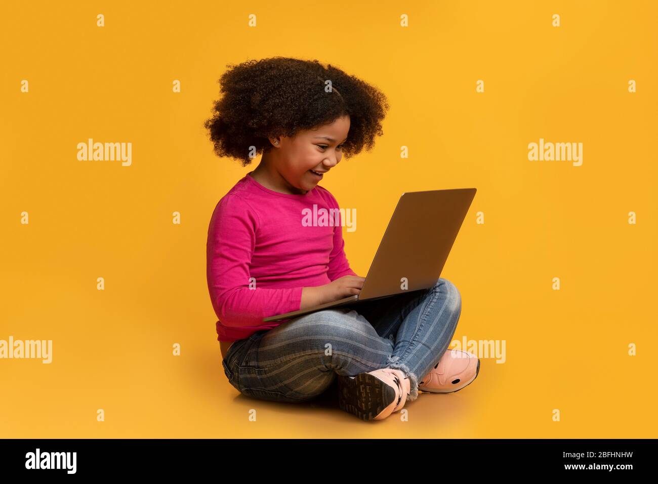 Modern Technologies For Kids. Black girl sitting with laptop on lap ...