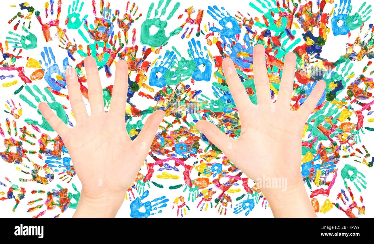 Hands on colorful handprints background Stock Photo - Alamy