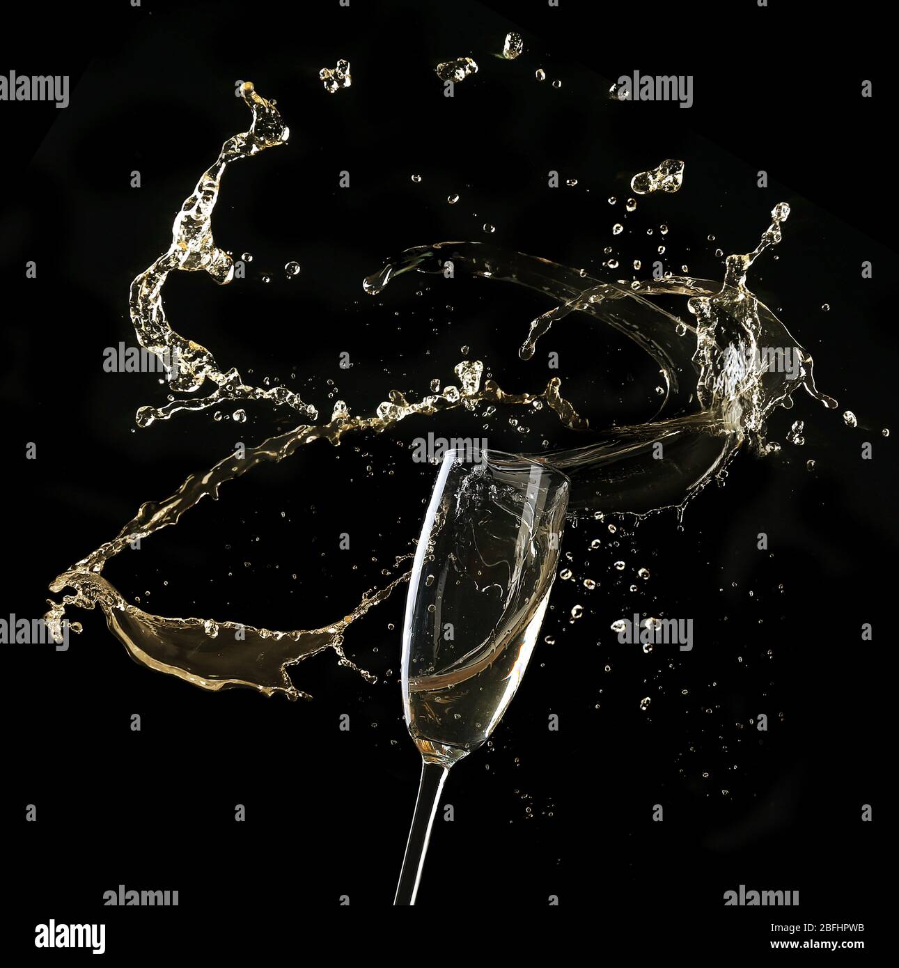Glass of champagne with splash, on black background Stock Photo - Alamy