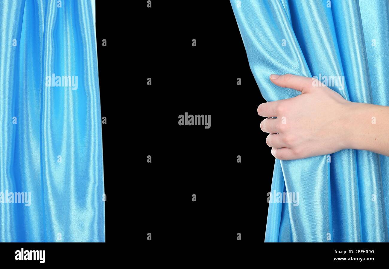Hand opening curtain on black background Stock Photo - Alamy
